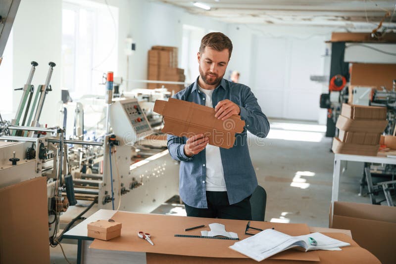 Raw Material, Bunch of Cardboards. Handsome Man is Working at the ...