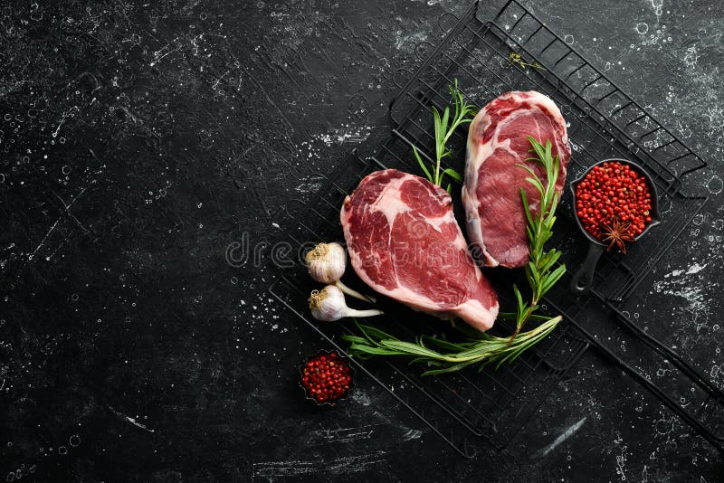 Raw Meat Background. Meat on a Black Stone Background with Spices and ...
