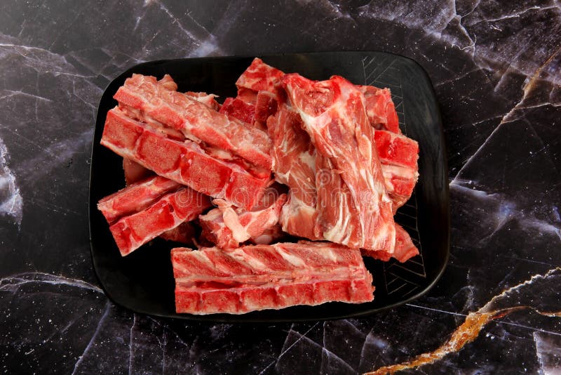 Raw Meat with Bone on Clay Plate and Luxury Marble Background. Raw Meat ...