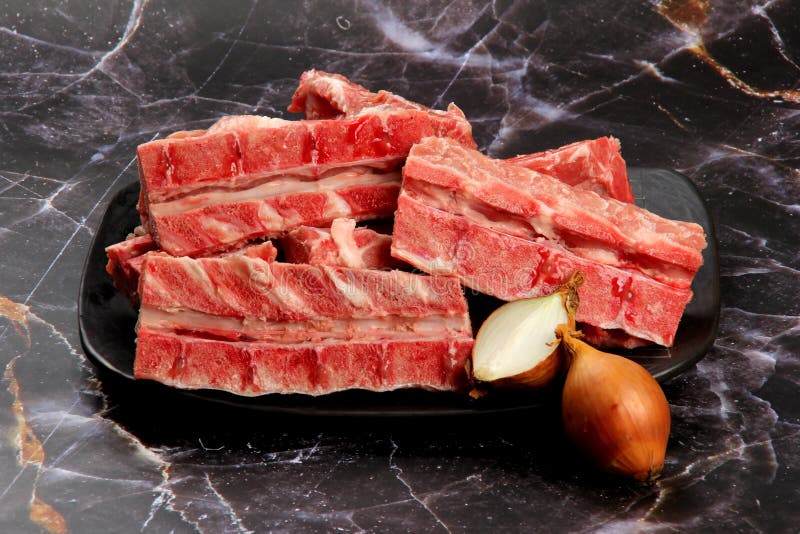 Raw Meat with Bone on Clay Plate and Luxury Marble Background. Raw Meat ...