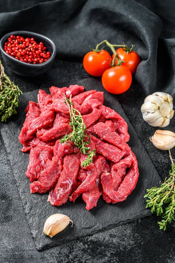Raw Beef Strips Slices in a Kitchen Tray with Rosemary and Thyme. White ...