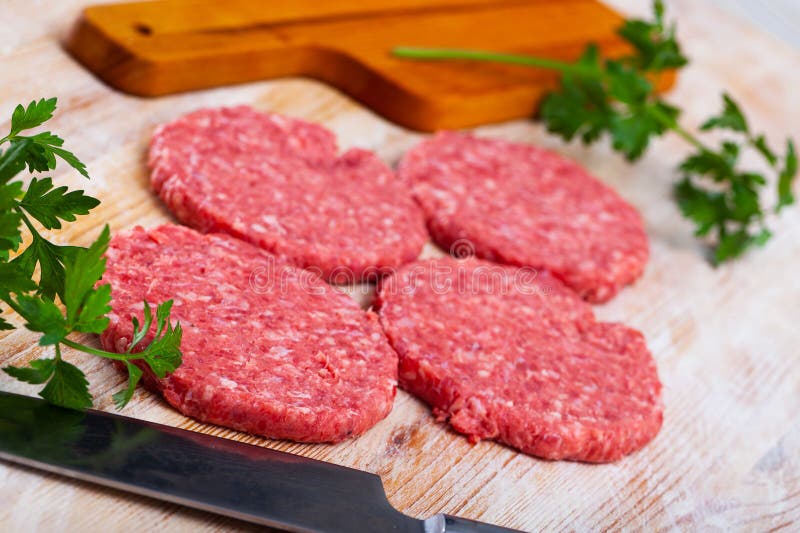 Raw Meat Cutlets with Parsley on Wooden Board Stock Image - Image of ...