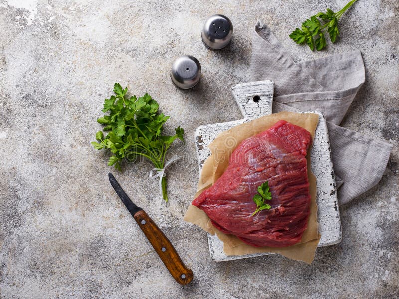 Raw meat on cutting board stock image. Image of steak - 146236753