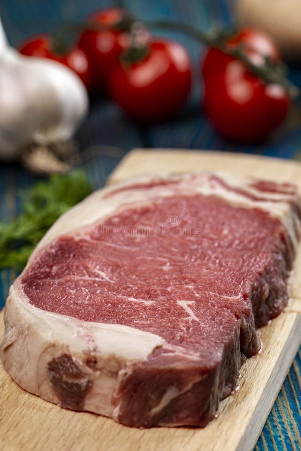 Raw Meat on Cutting Board with Spices on Wooden Background Stock Image ...