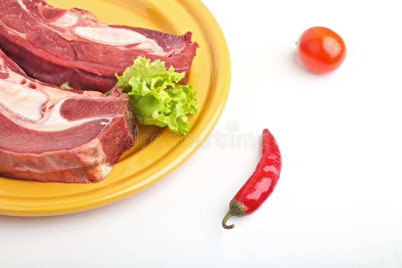 Raw Meat on a Plate with a Tomato and Pepper Salad Stock Image - Image ...