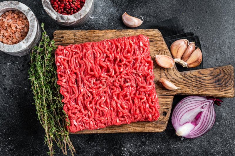 Raw Mince, Minced Ground Beef Meat on a Cutting Board. Black Background ...