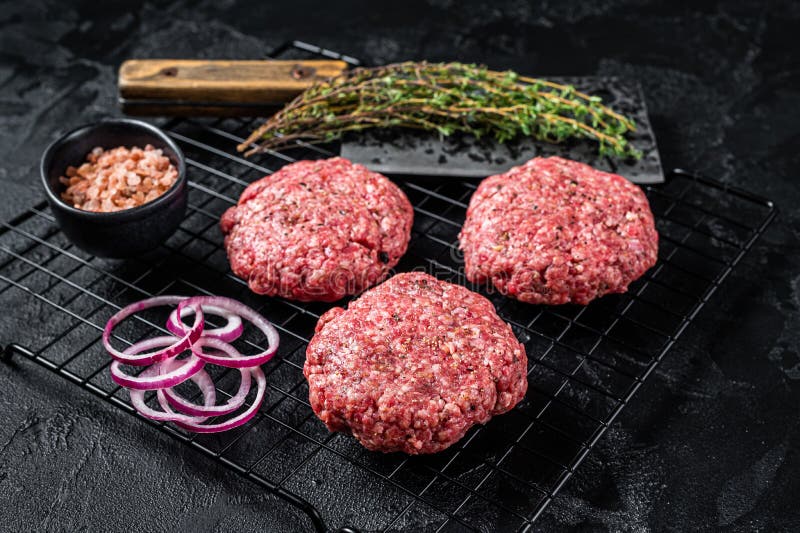 Raw Minced Beef Cutlets with Spices and Herbs Ready for Cooking. Black ...