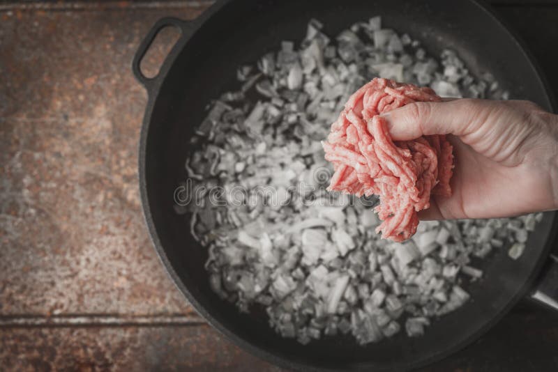 Raw Minced Meat in the Hand with Blurred Pan Top View Stock Photo ...