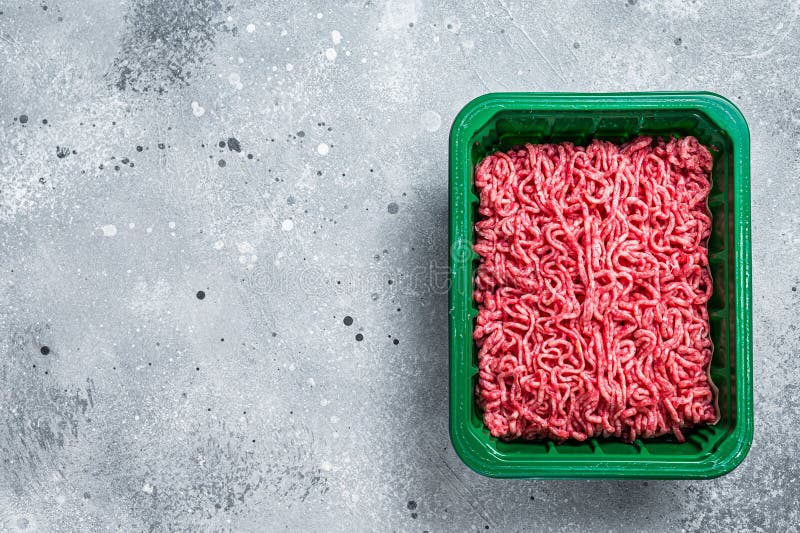 Raw Minced Meat in a Plastic Container, Ground Beef. Gray Background ...