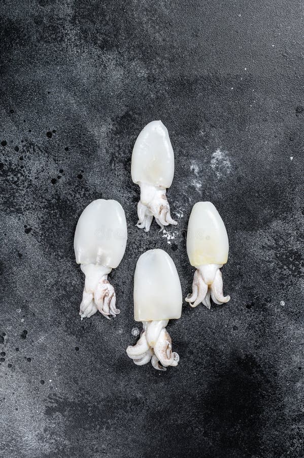 Raw Mini Cuttlefish with Chili Pepper and Parsley on a Cutting Board ...