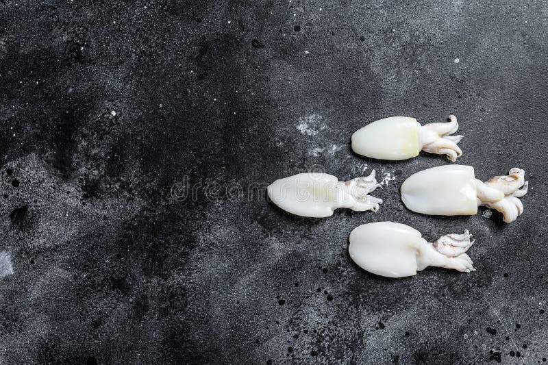 Raw Mini Cuttlefish with Chili Pepper and Parsley on a Cutting Board ...