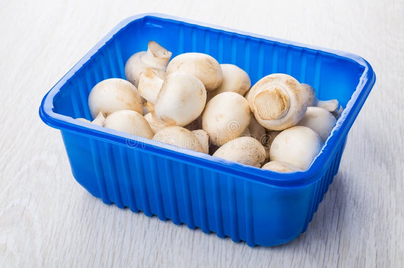 Raw Mushrooms in Blue Plastic Container, Kitchen Knife on Table Stock ...