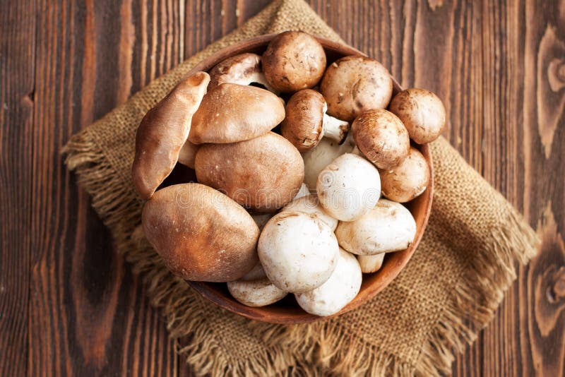 Raw Mushrooms on Rustic Table Stock Photo - Image of mushroom, table ...