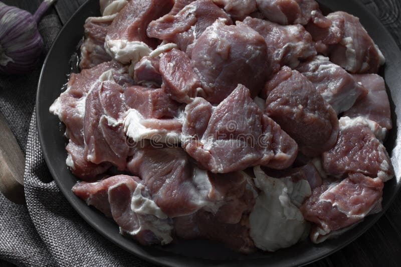 Raw Mutton Cut into Medium Pieces, Lay on a Plate, Surrounded by Garlic ...