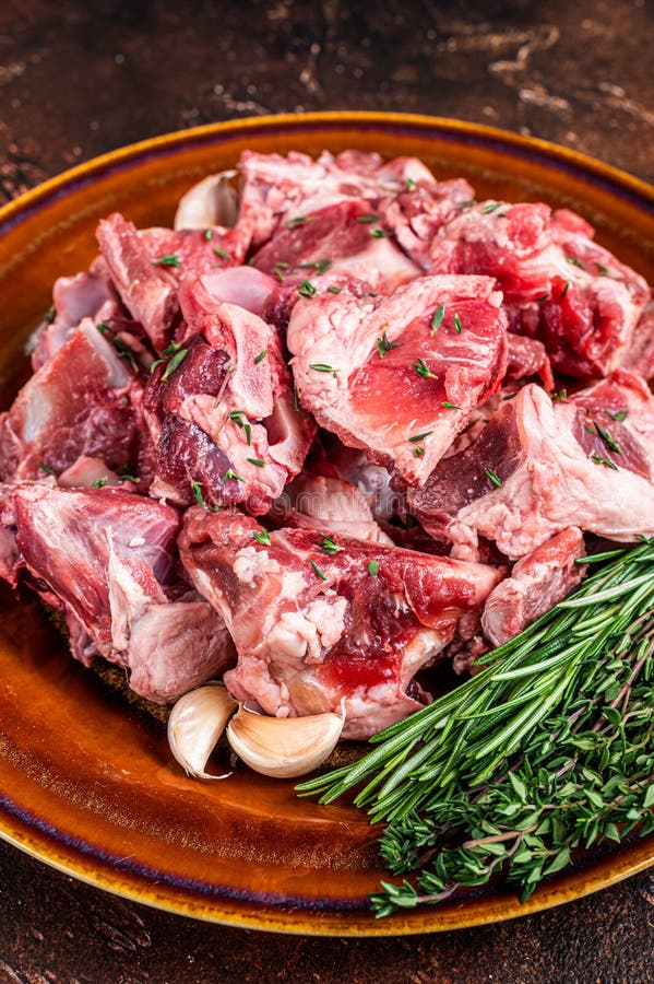 Raw Mutton Meat Diced for Goulash or Stew with Bone on a Rustic Plate ...