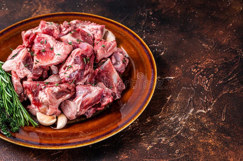 Raw Mutton Meat Diced for Goulash or Stew with Bone on a Rustic Plate ...