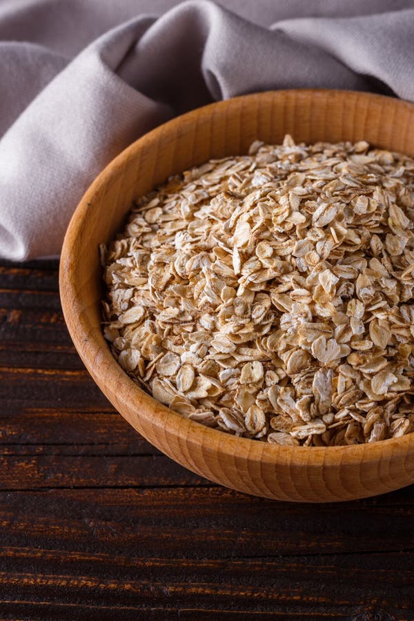 Raw Oatmeal on a Wooden Rustic Background Stock Photo - Image of bowl ...