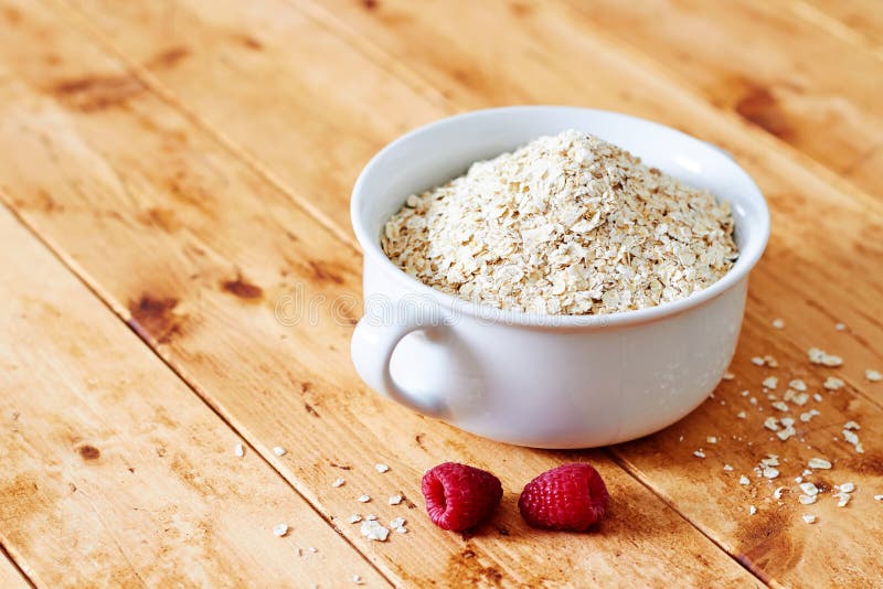 Raw Oatmeal on Wooden Table Stock Photo - Image of background, cereals ...