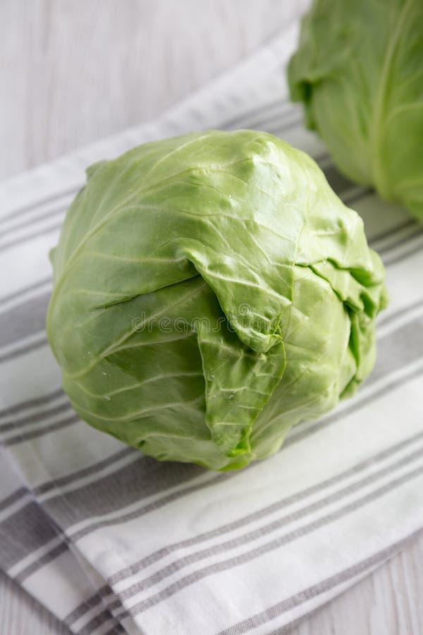 Raw Organic Cabbage on a White Wooden Background, Side View. Close-up ...