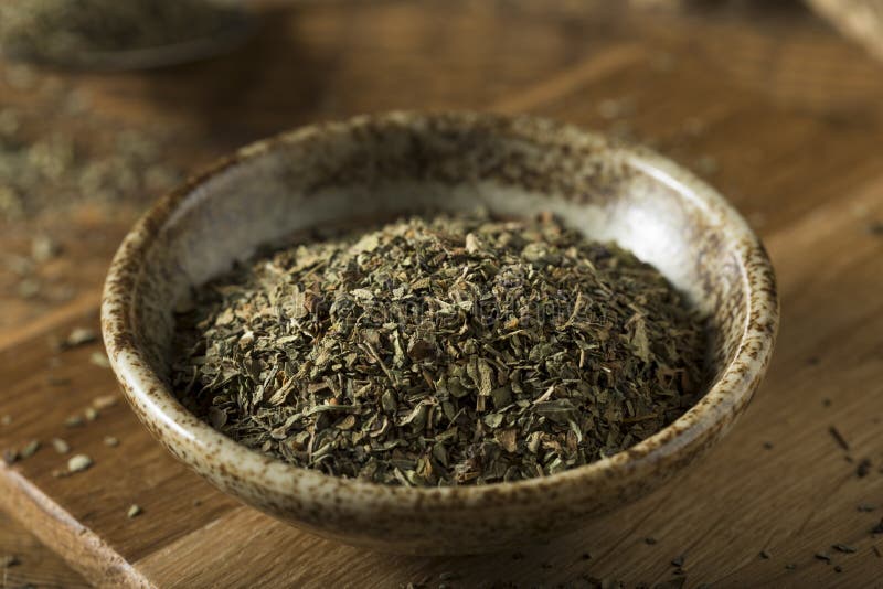 Dried Basil Crushed With Green Leaves In A Wooden Bowl Stock Image ...