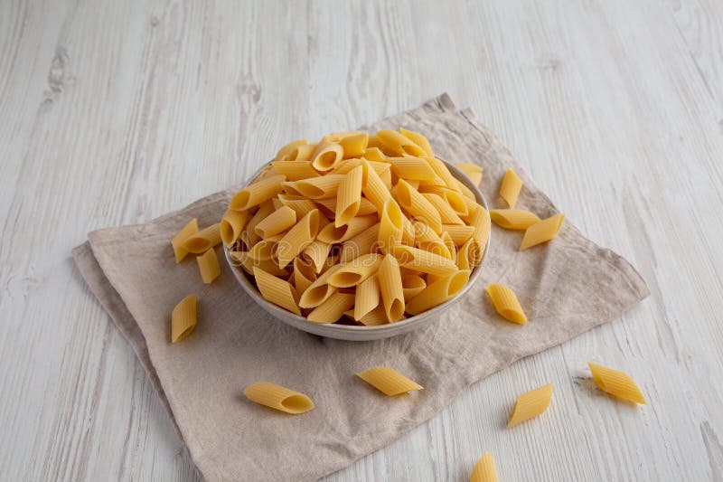 Raw Organic Dry Pennoni Pasta in a Bowl, Side View Stock Image - Image ...