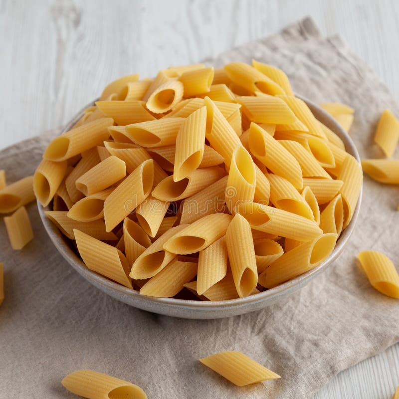 Raw Organic Dry Pennoni Pasta in a Bowl, Side View Stock Image - Image ...