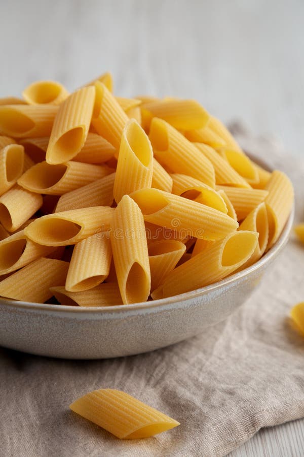Raw Organic Dry Pennoni Pasta in a Bowl, Side View Stock Photo - Image ...