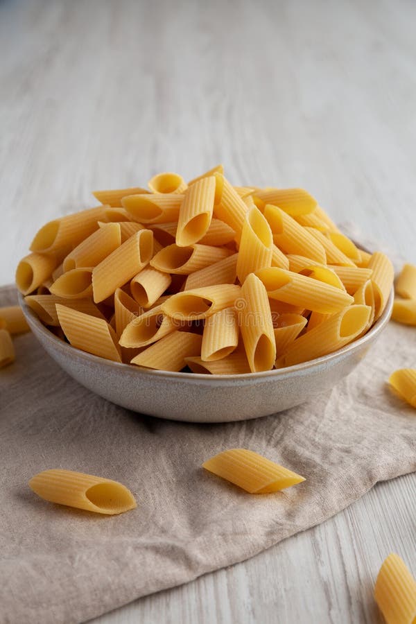 Raw Organic Dry Pennoni Pasta in a Bowl, Side View Stock Photo - Image ...
