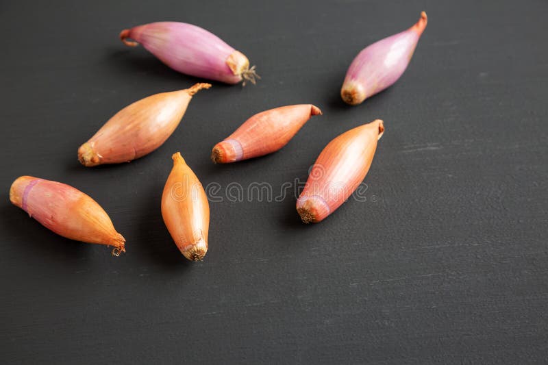 Raw Organic Shallots on a Black Background, Side View Stock Photo ...