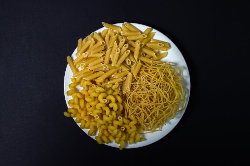 Raw Pasta on a Black Background. Different Varieties of Pasta Stock ...