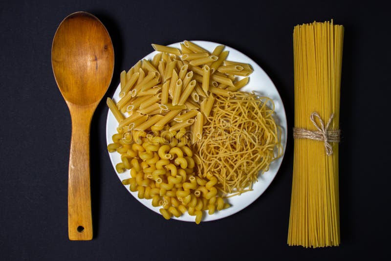 Raw Pasta on a Black Background. Different Varieties of Pasta Stock ...