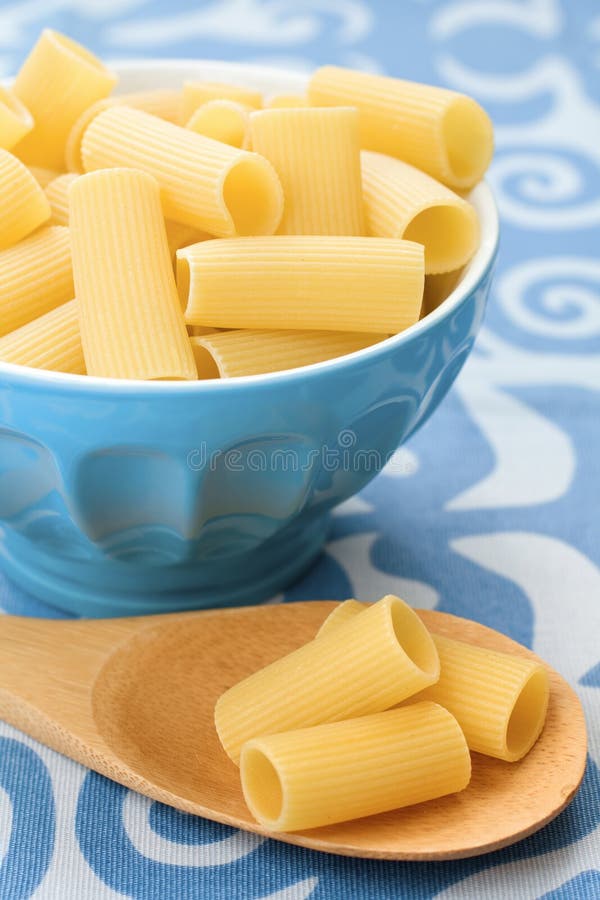 Raw pasta in a blue bowl stock image. Image of cuisine - 11681659
