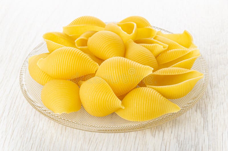Raw Pasta Conchiglie in Plate on Wooden Table Stock Photo - Image of ...