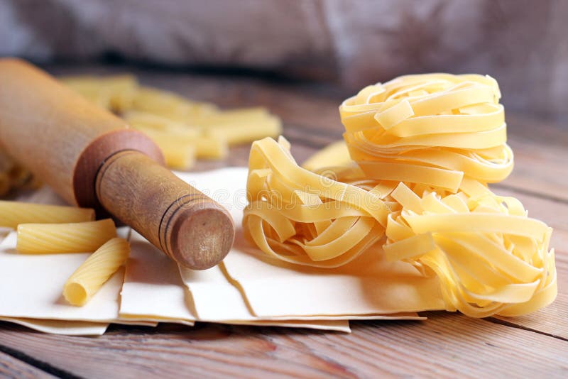 Raw Pasta with Rolling Pin on a Table Stock Photo - Image of life ...