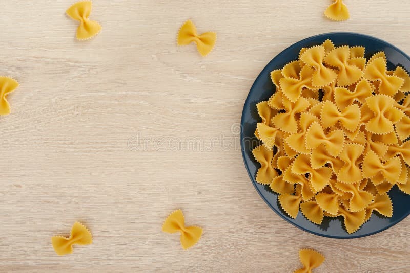 Raw Pasta in the Shape of a Bow on a Plate, Top View, Copy Space Stock ...