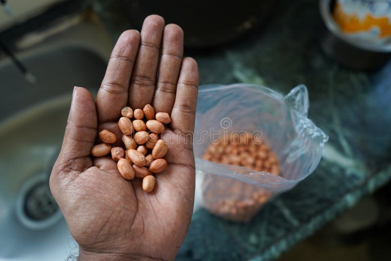 Raw peanuts in the hand stock photo. Image of market - 258393218