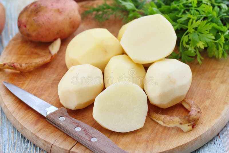 Raw peeled potatoes stock photo. Image of segment, organic - 75656260