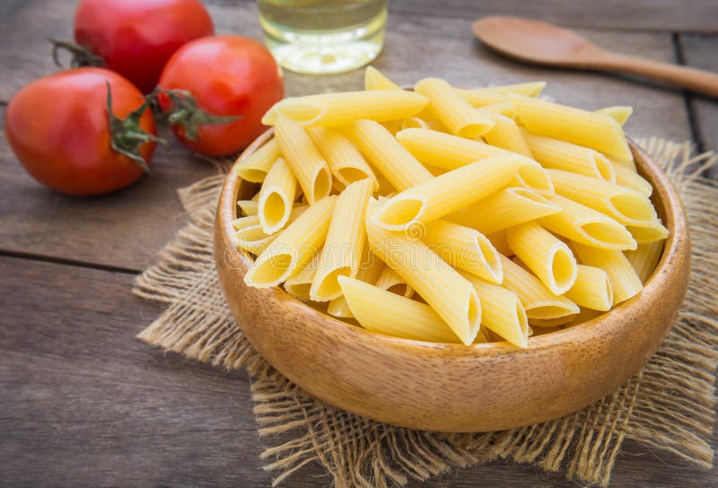 Raw Penne Pasta in Wooden Bowl Stock Photo - Image of mats, heap: 53728722