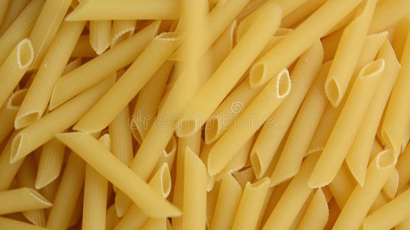 Raw Penne Rigate Pasta, Unspun and Sprinkled on Top. Feather Shaped ...