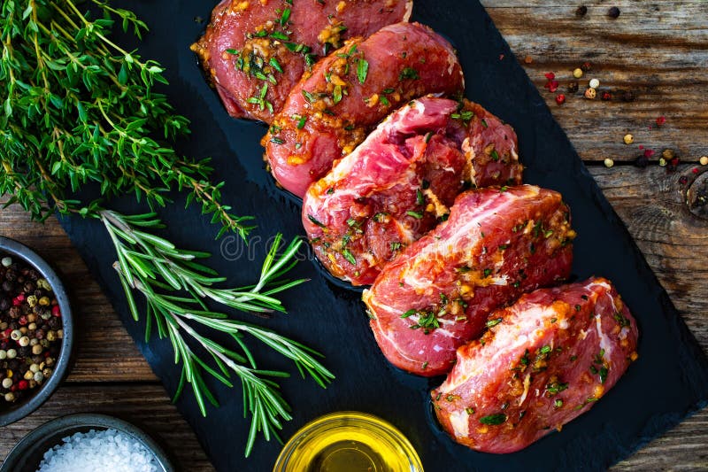 Raw Pickled Pork Cheeks on Stony Cutting Board on Wooden Table Stock ...