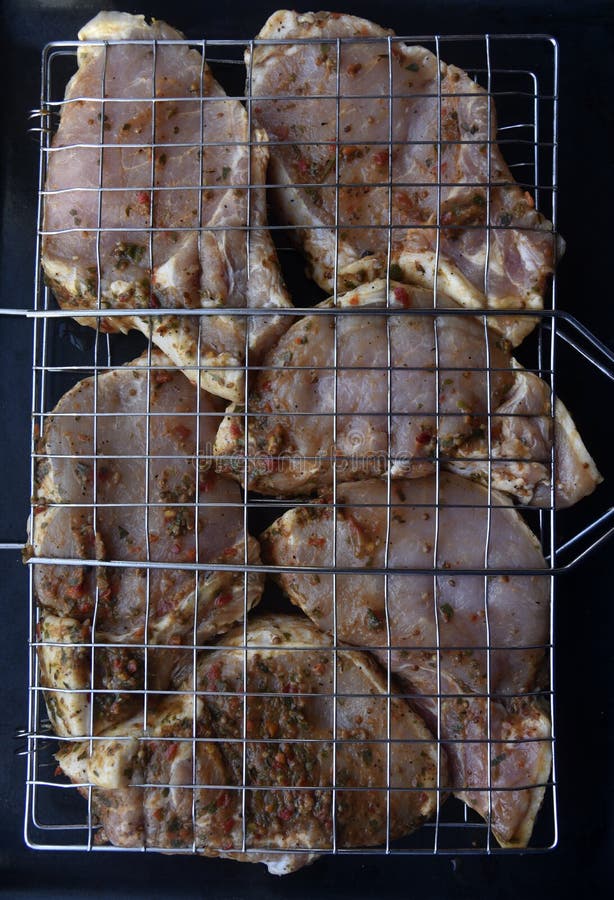 Raw Pickled Pork Meat in an Iron Mesh. Barbecue Grilling Net Stock ...
