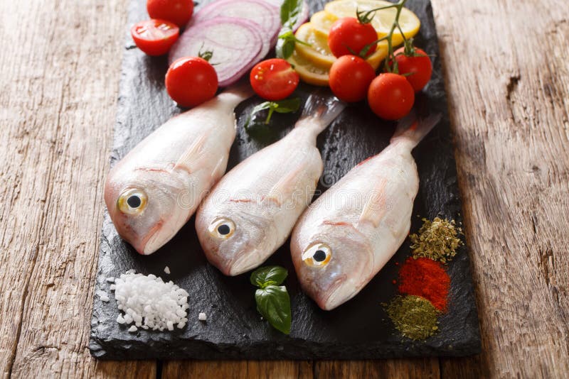 Raw Pink Dorado or Gilt-head Sea Bream Fish with Spices, Vegetables and ...