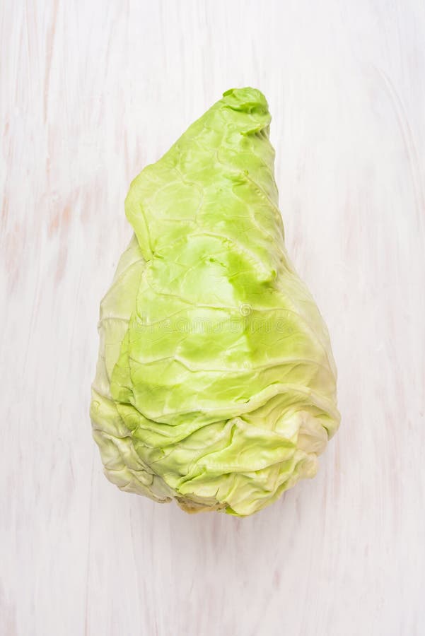 Raw Pointed Cabbage Head on White Wooden Background Stock Photo - Image ...