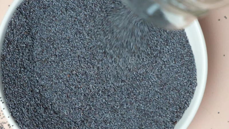 Raw Poppy Seeds Pouring into Plate Top View Slow Motion. Stock Video ...