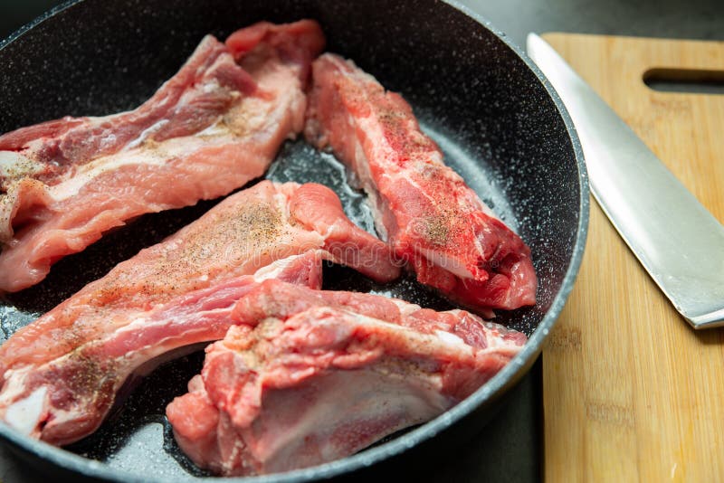 Raw Pork Ribs are Fried in Oil in a Frying Pan Stock Image - Image of ...