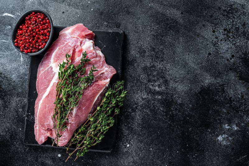 Raw Pork Shoulder Meat Cut on a Marble Board. Black Background. Top ...