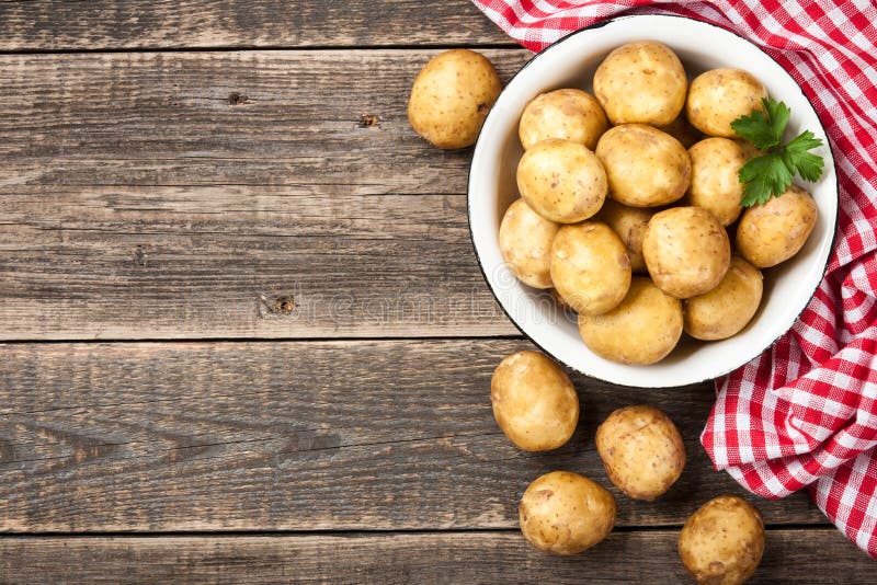 Raw potato on wooden table stock image. Image of vegetable - 95057913