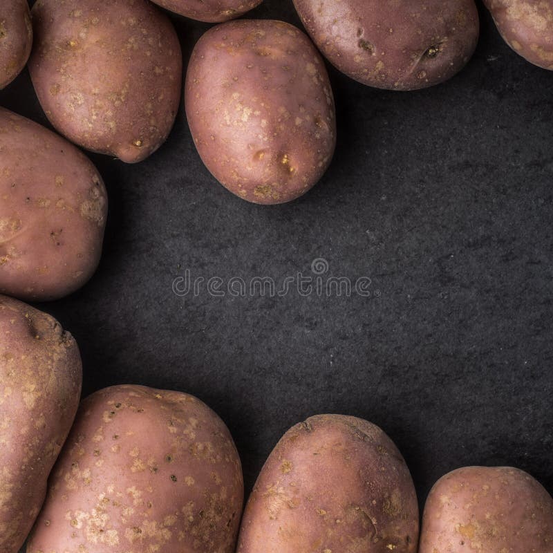 Raw Potatoes at the Left of the Black Stone Table Square Stock Photo ...