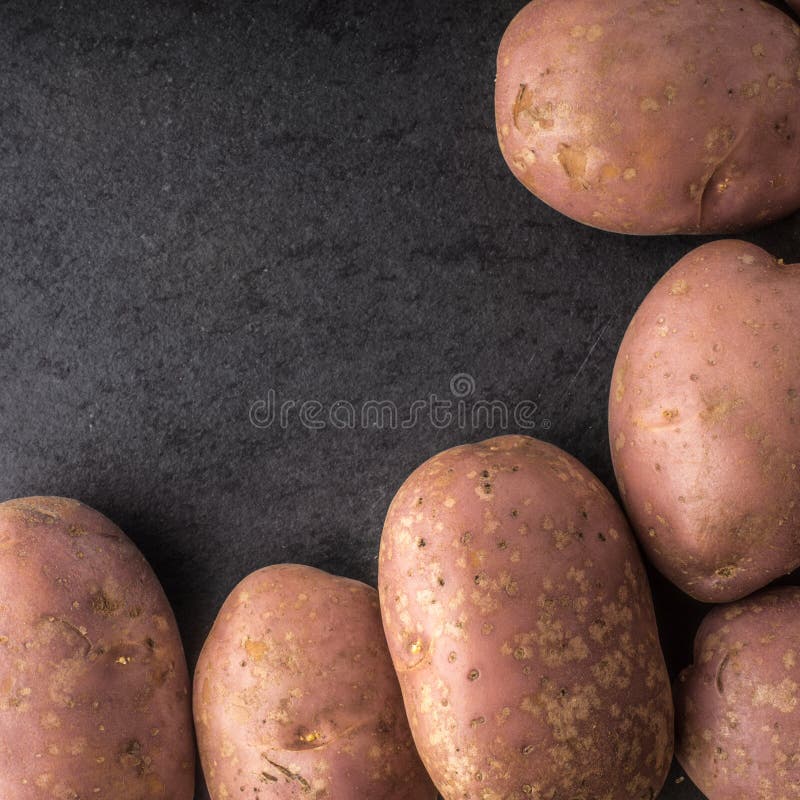 Raw Potatoes at the Right of the Black Stone Table Square Stock Image ...