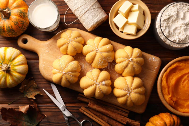Raw Pumpkin Shaped Buns and Ingredients on Wooden Table, Flat Lay Stock ...